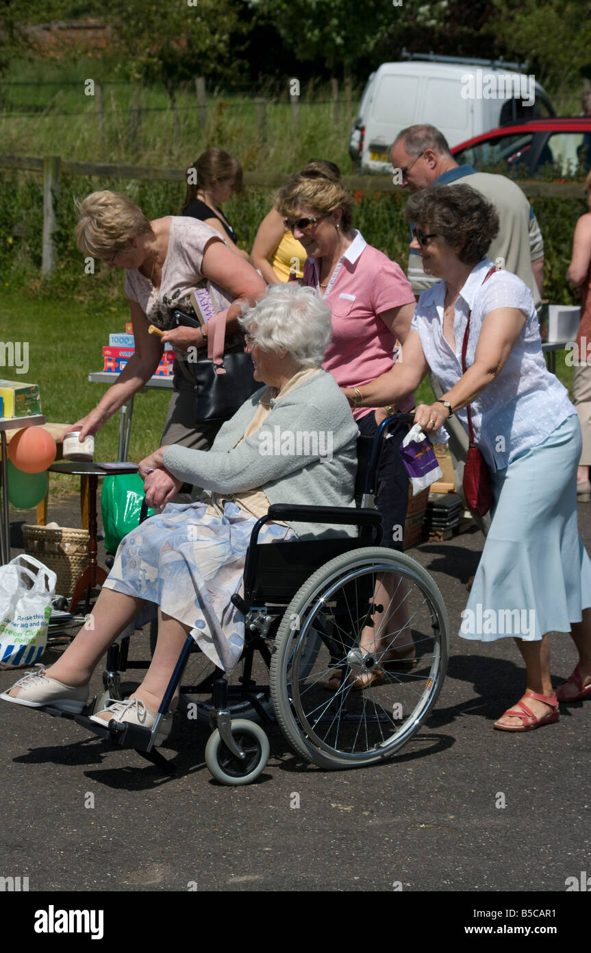 Elderly woman person sitting in a wheelchair being pushed Stock Photo ...