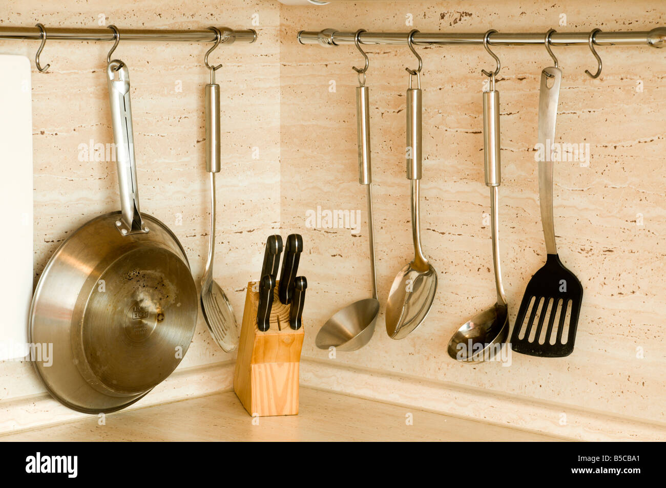 Kitchenware hanging on the wall Stock Photo - Alamy