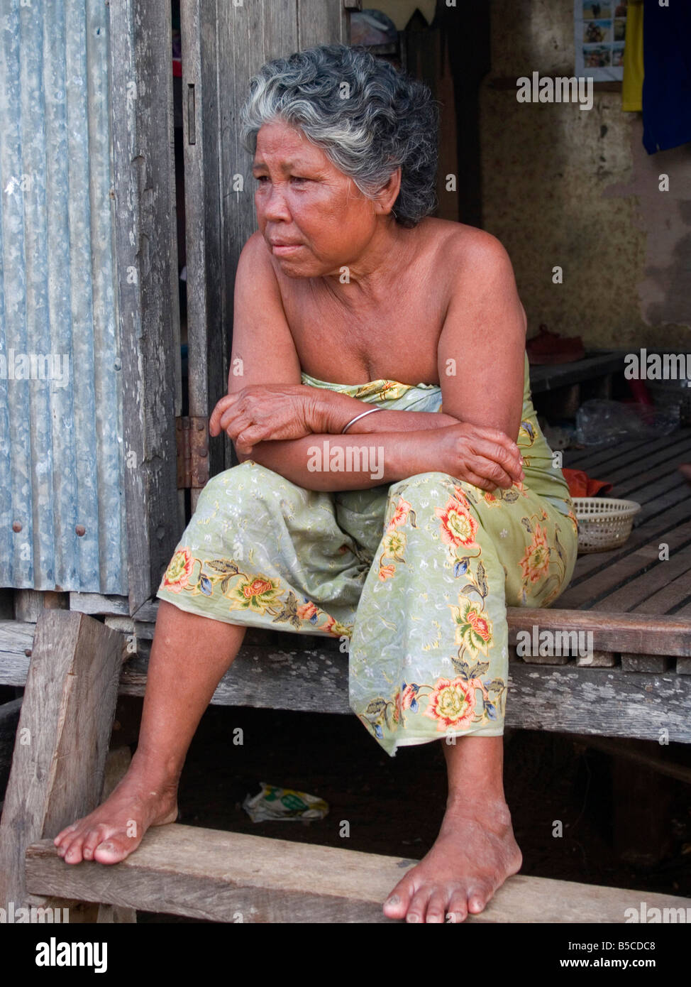 sea gypsy woman sitting in front of her home in Rawai Beach in Phuket ...
