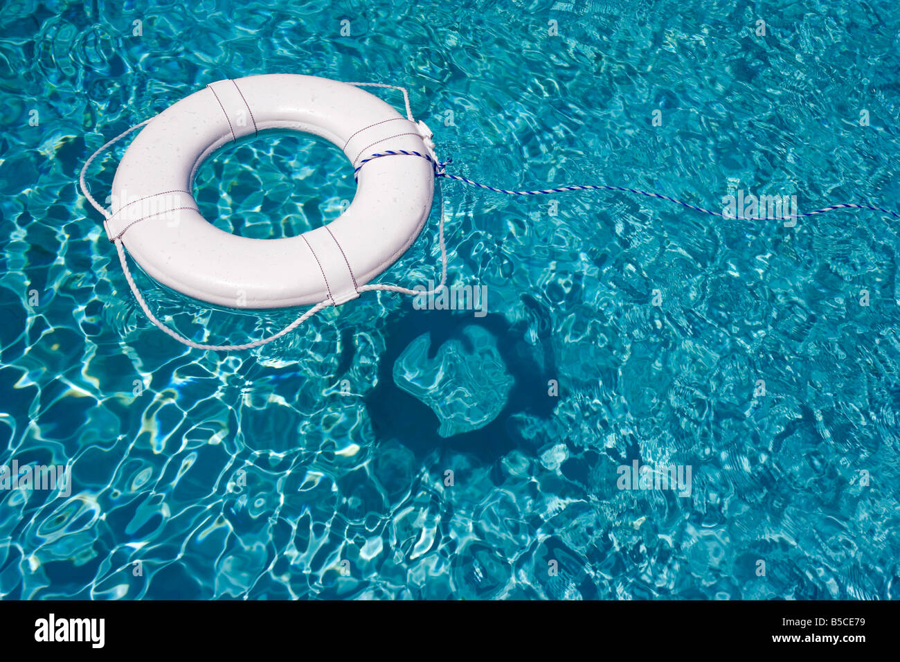 A life preserver floating in a pool Stock Photo - Alamy