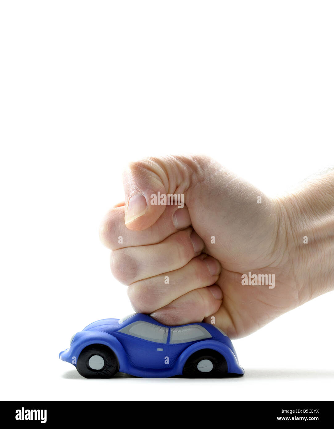 A MODEL CAR HIT AND SQUASHED BY A MANS FIST Stock Photo - Alamy