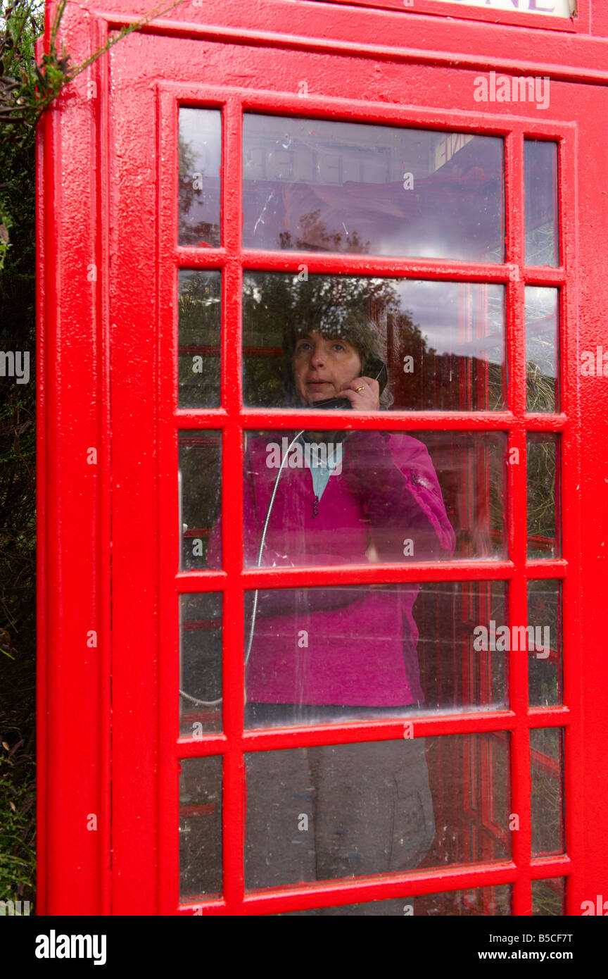 Woman using red BT phone box Scotland UK Stock Photo - Alamy