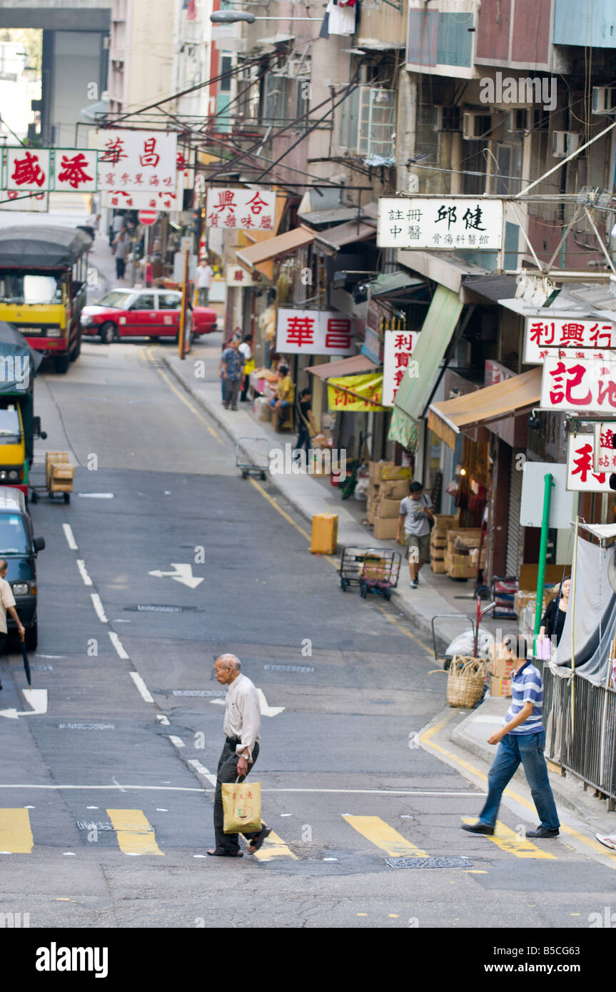 Old man crossing Hong Kong street Stock Photo - Alamy