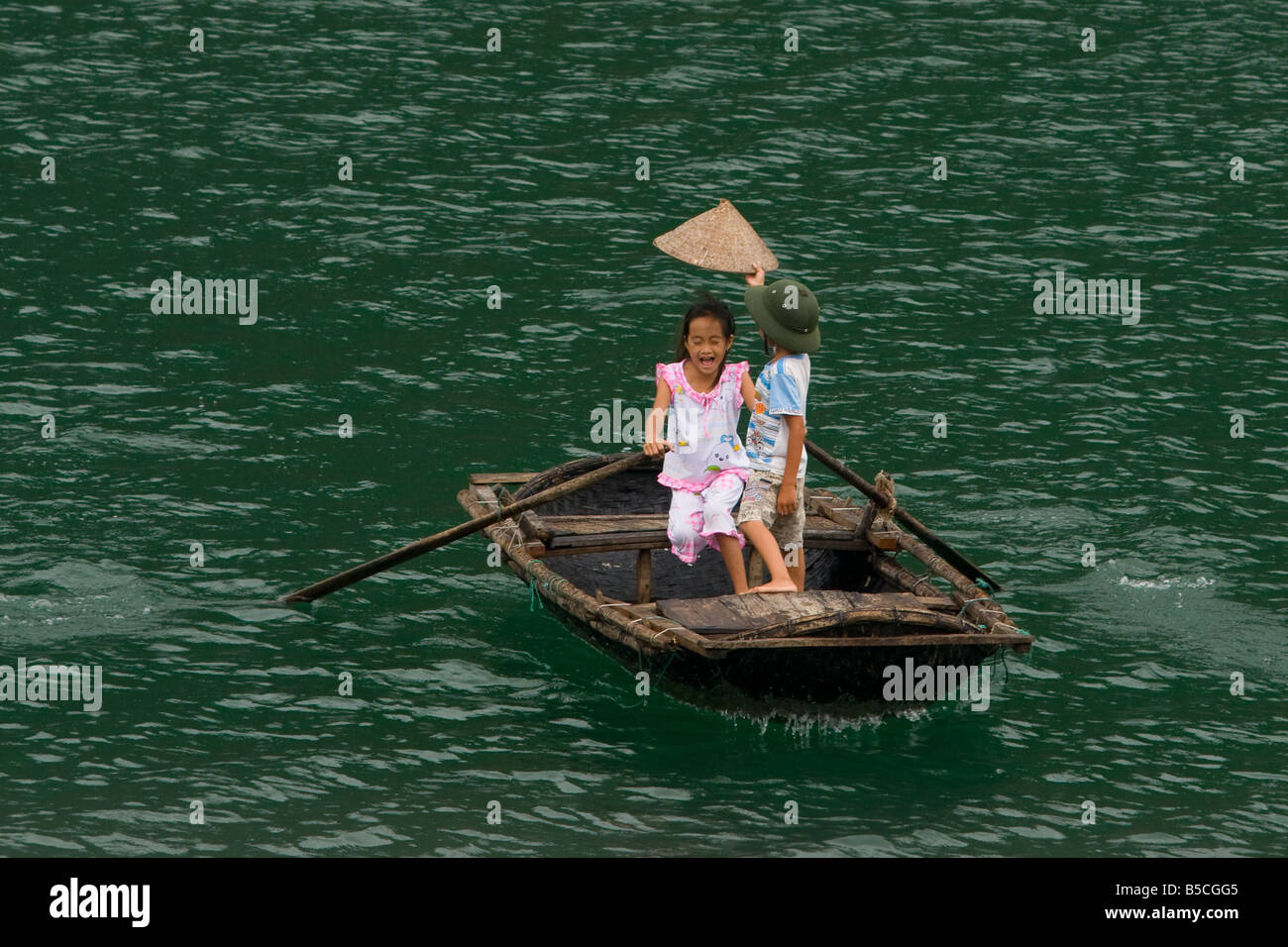Kids from a fisherman village having fun and laughing on their boat ...