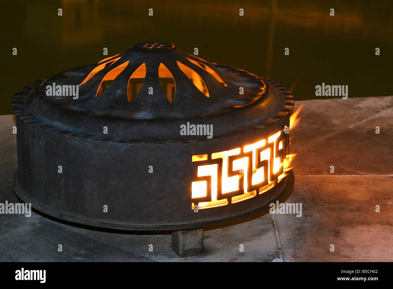 iron cast pot with fire burning inside Stock Photo - Alamy