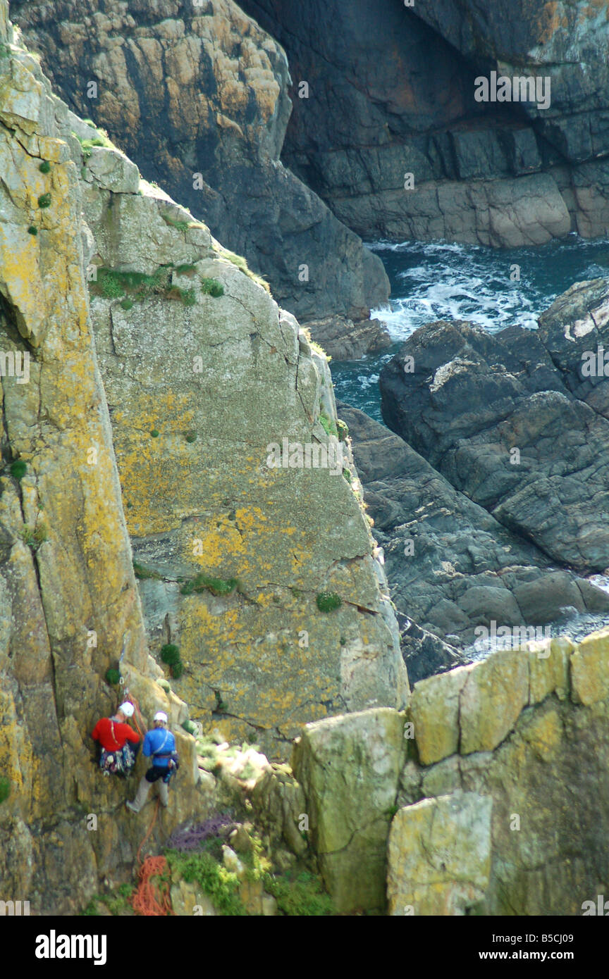 Rock climbers on cliff of South Stack, on Anglesey in Wales England UK ...