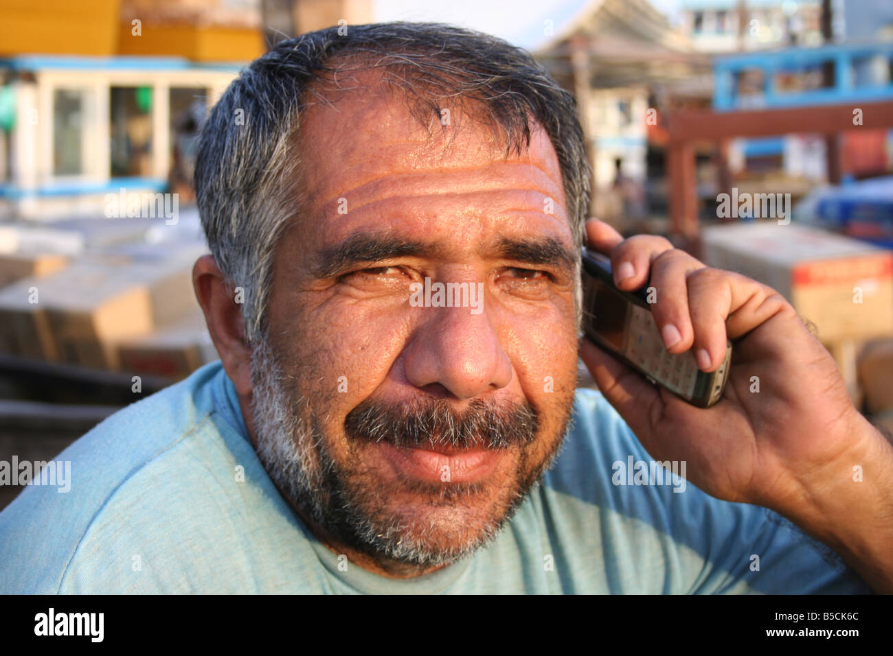 Sailor worker mobile phone Deira creek dubai uae Stock Photo - Alamy