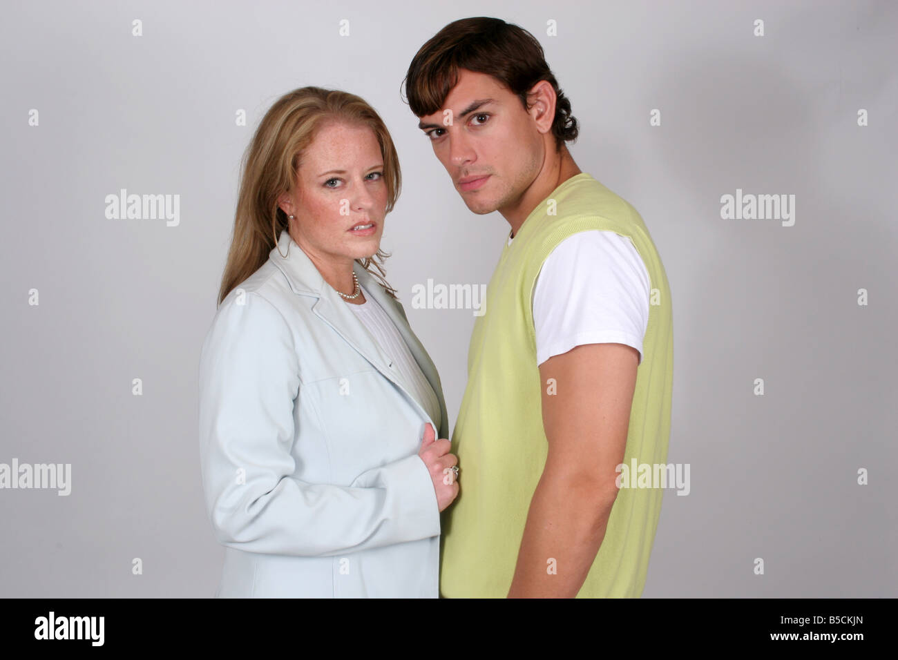 A couple standing together and looking at the camera Stock Photo - Alamy