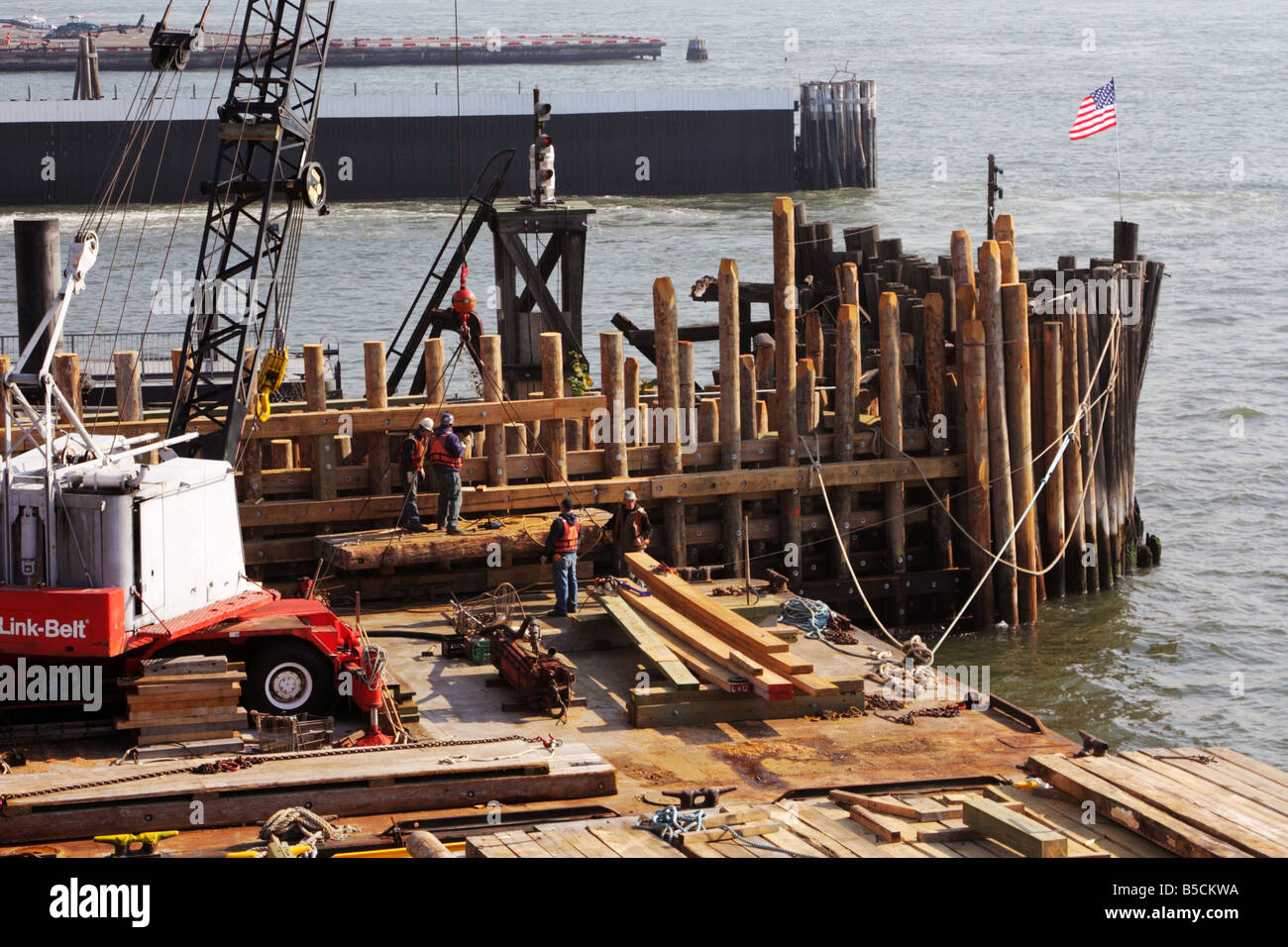 Workers repairing and replacing the wood pile and rack terminal in ...