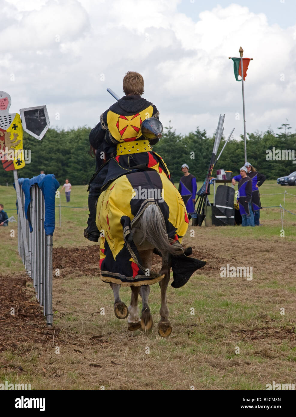 Rear view of a knight on horse at a joust Stock Photo - Alamy