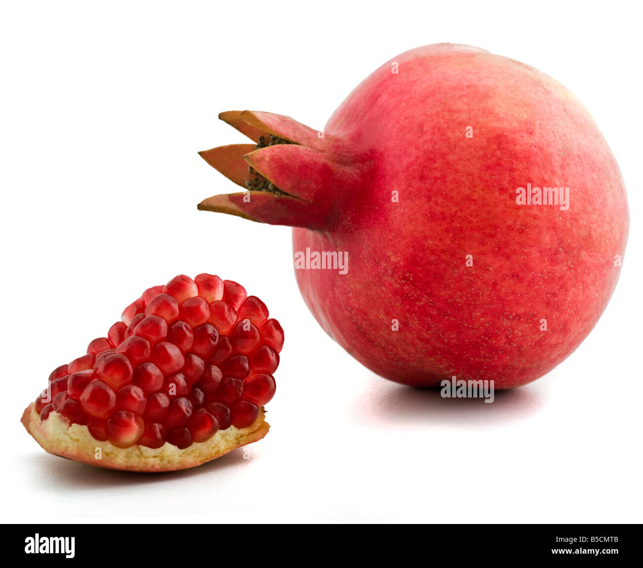 whole and slice of pomegranate isolated on white Stock Photo - Alamy