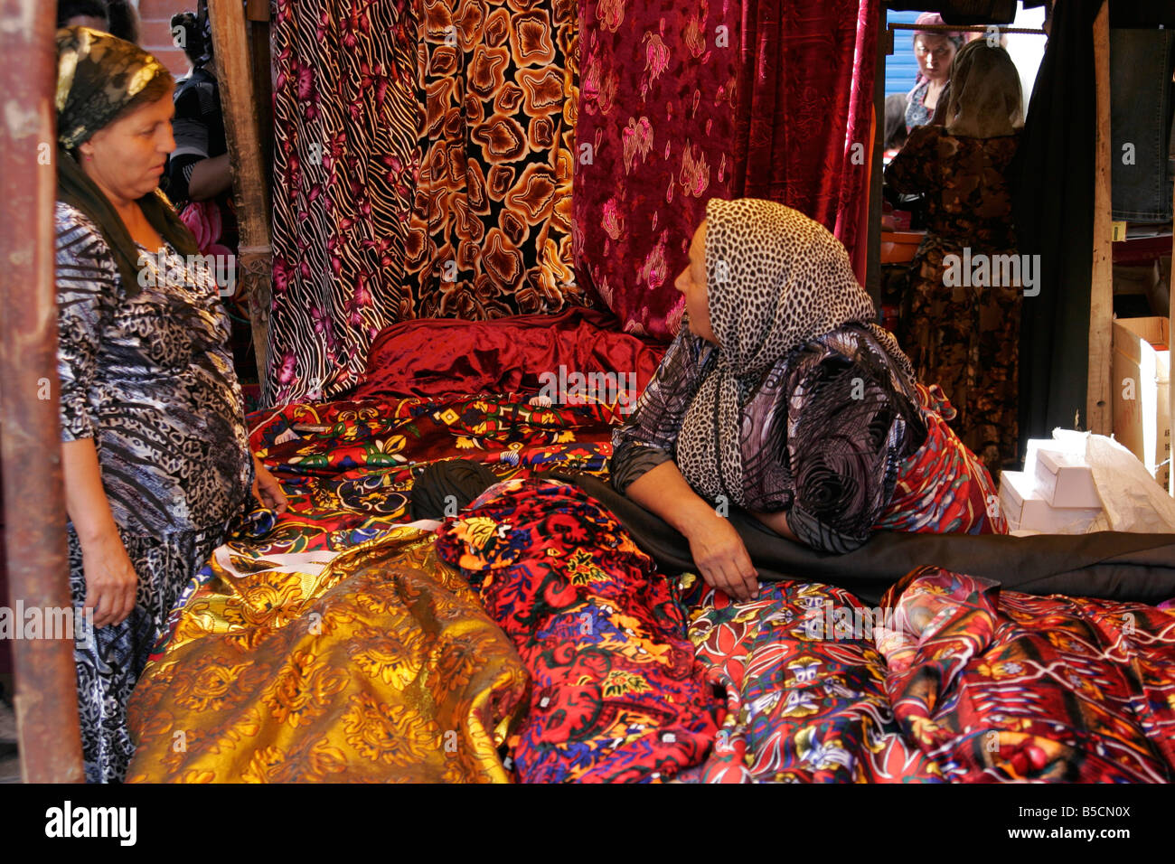 Uzbek woman selling textile, market in Osh, Kyrgyzstan, Central Asia ...