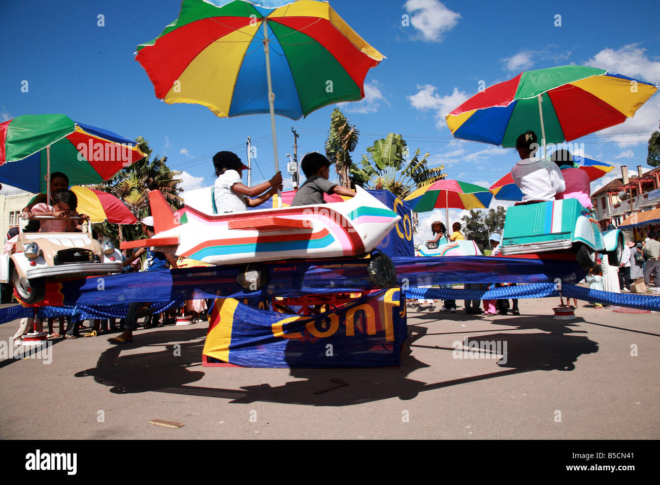 Children in a colourful carousel at the traditional May fair of ...