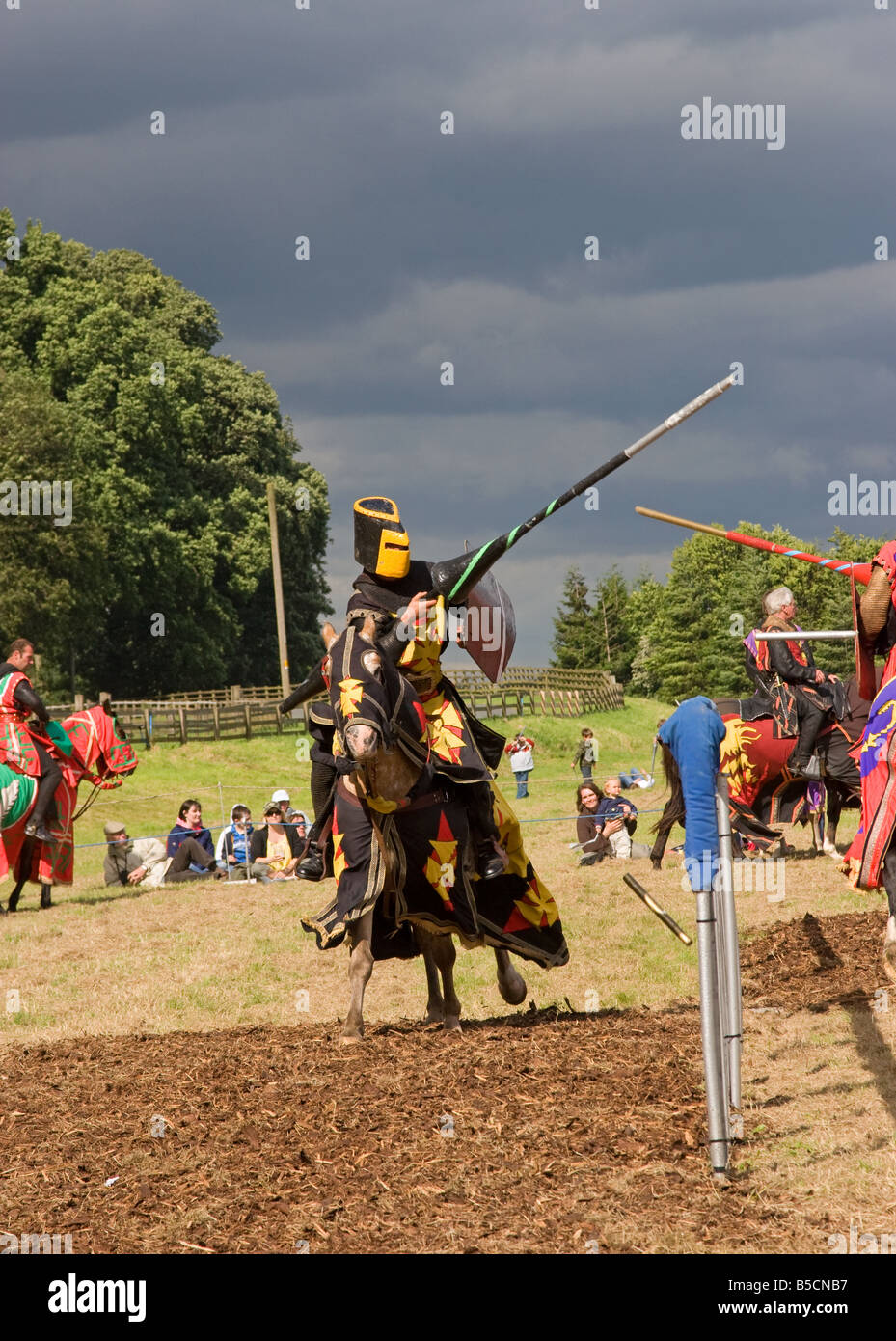 Knight on horse charging at a joust Stock Photo - Alamy