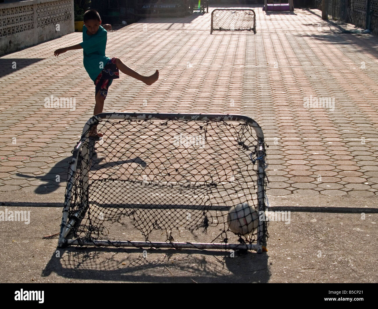 boy kicking a football goal in the moslem stilt village of Ko Panyi in ...