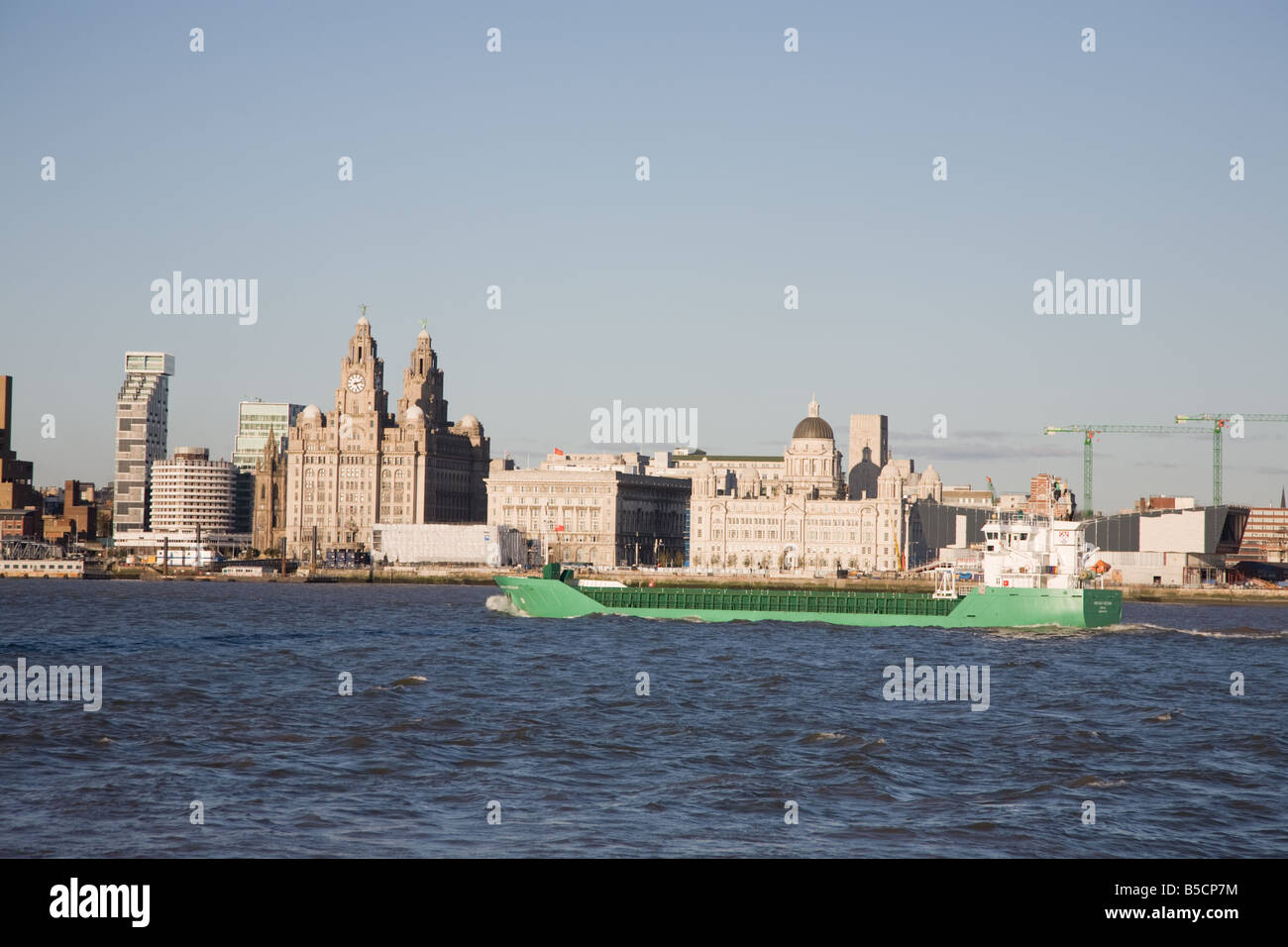 Cargo ship on river Mersey against the iconic Liverpool skyline Stock ...