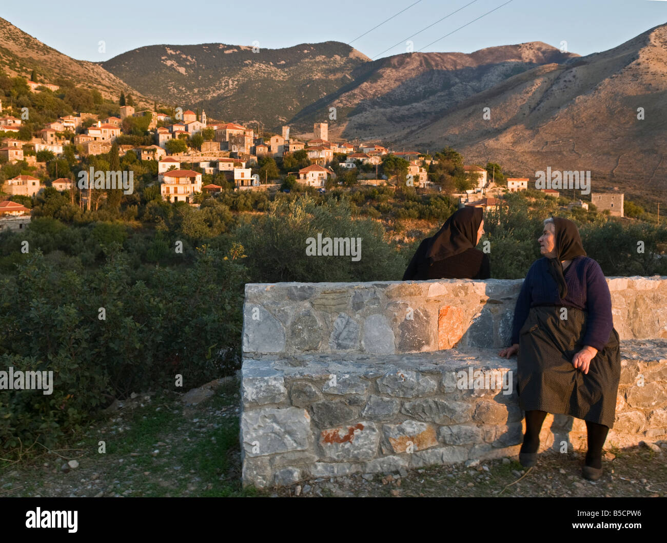 Villagers chatting in the evening light in the Outer Mani village of ...