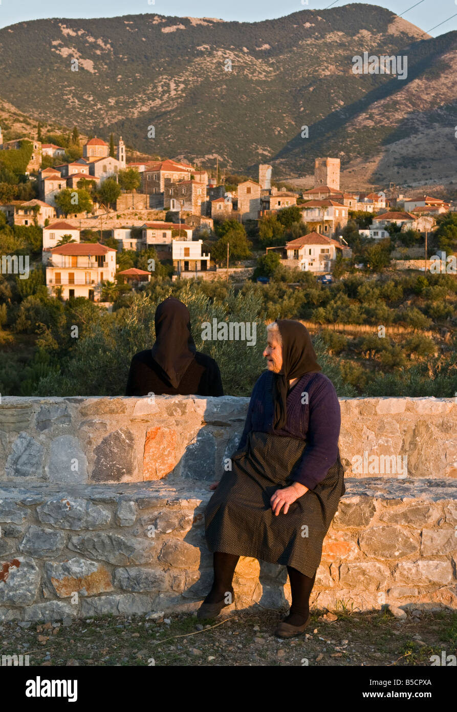 Villagers chatting in the evening light in the Outer Mani village of ...
