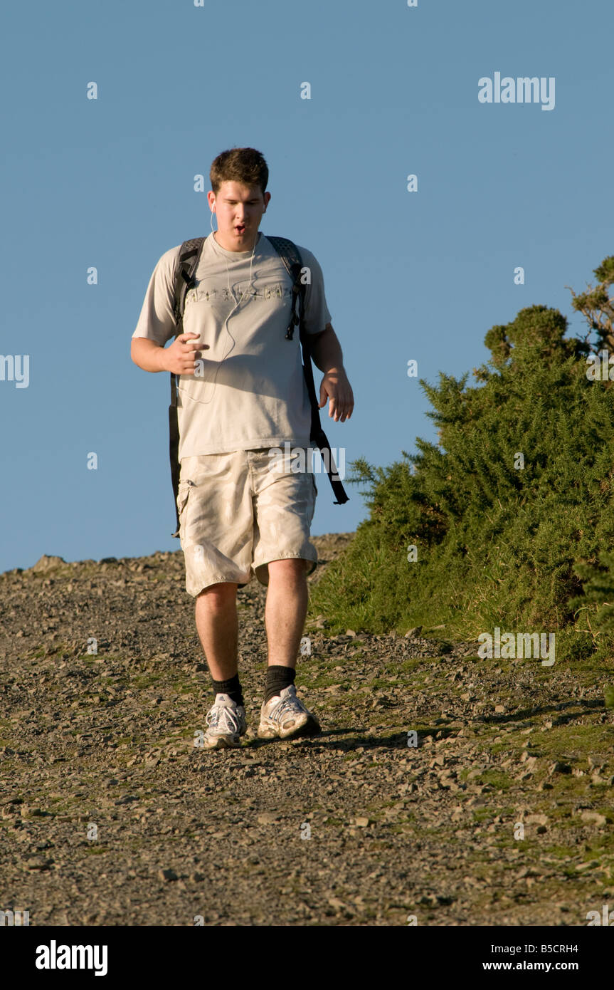 Young man walking on footpath late summer early autumn Wales UK Stock ...