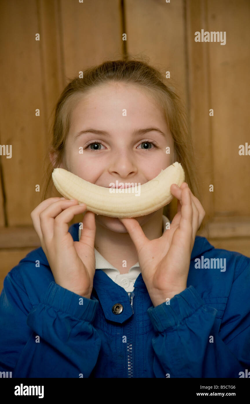 ten 10 year old girl happy looking smiley face with a banana Stock ...