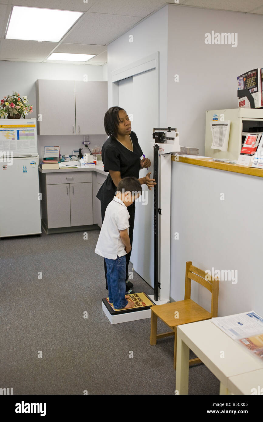 4 year old boy getting weighted by nurse at the doctors office Stock ...