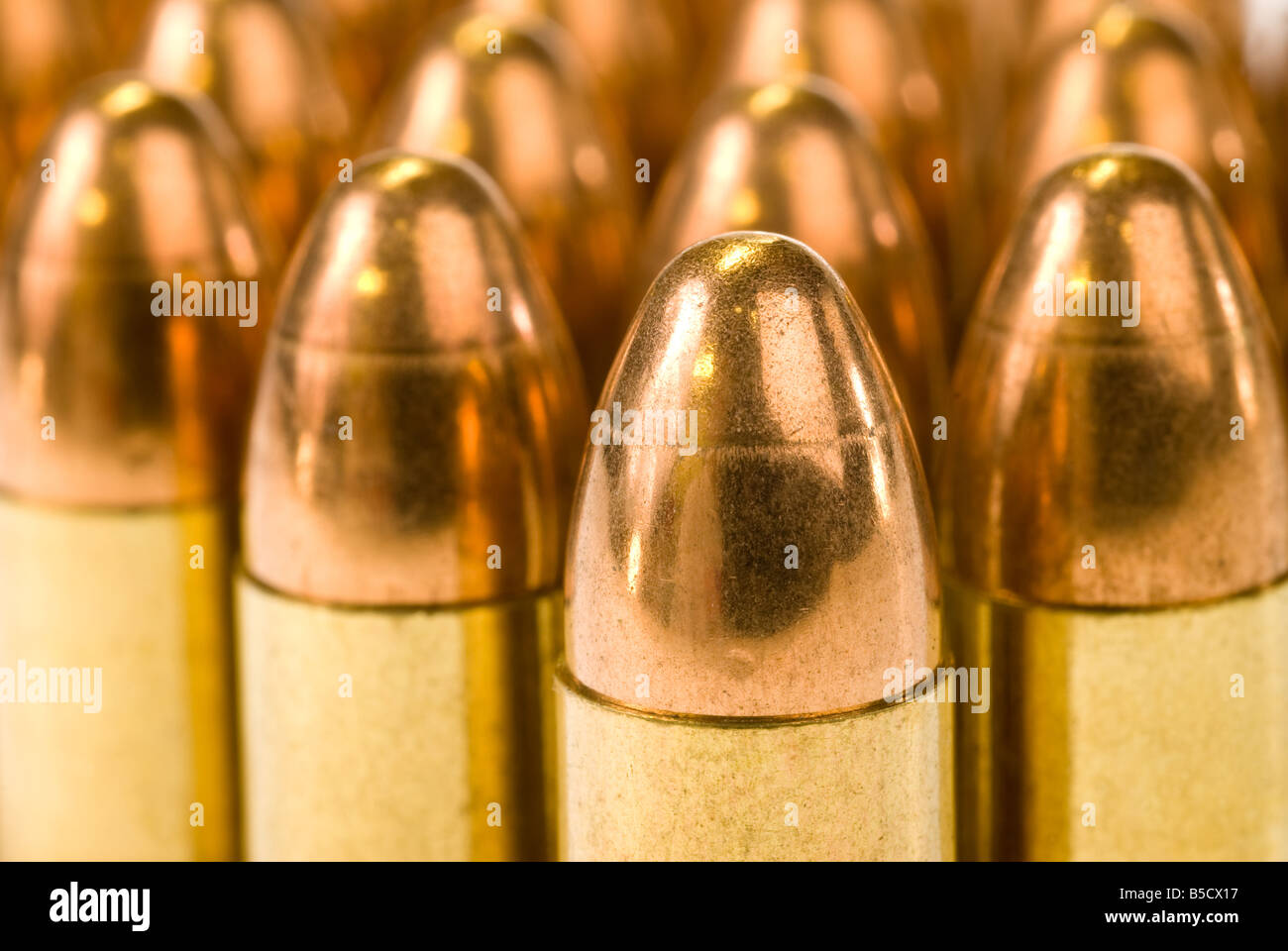 A stack of copper plated bullets with brass slugs lined in rows Stock ...
