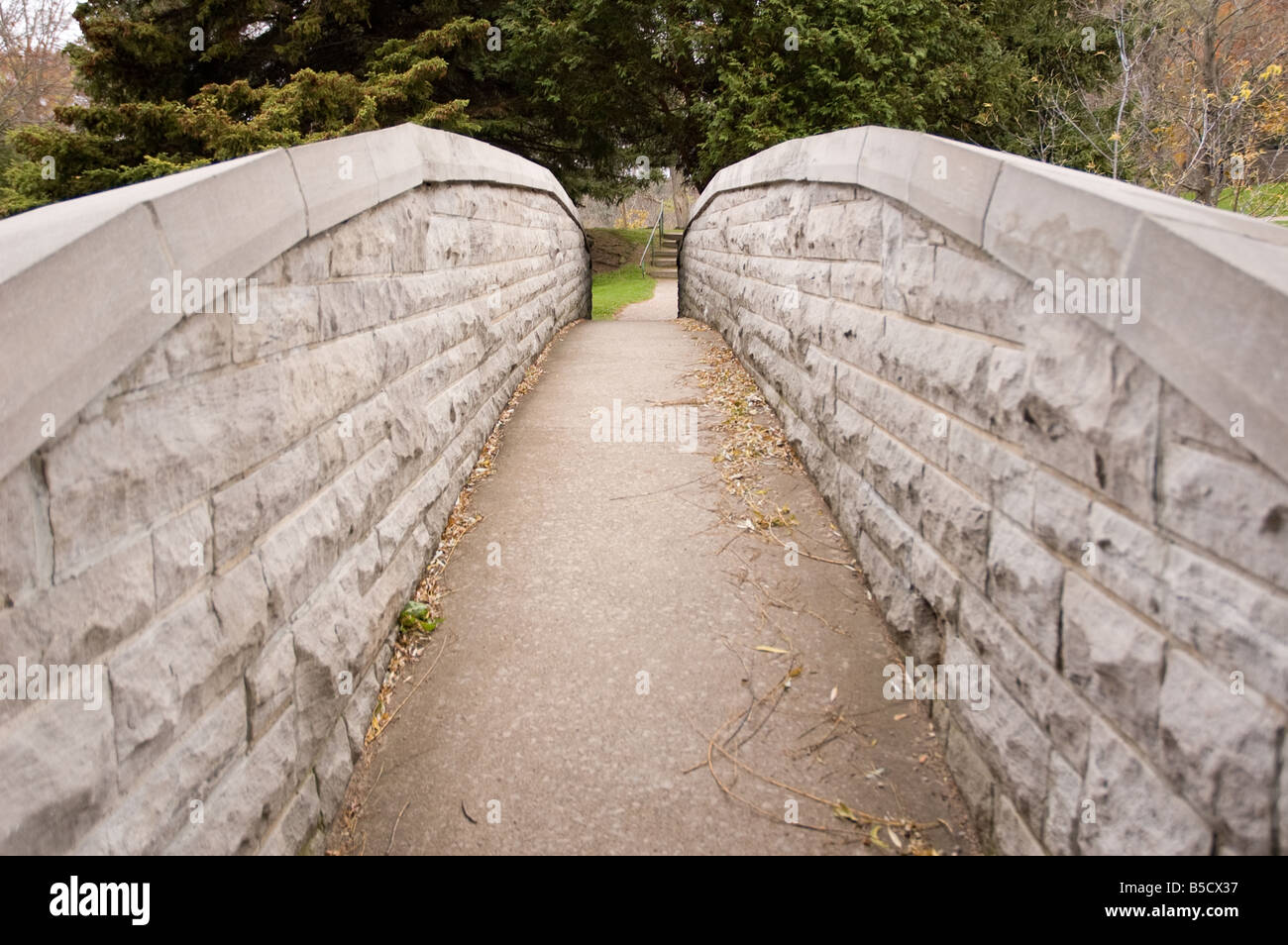 A narrow stone bridge stretches over a creek Stock Photo - Alamy