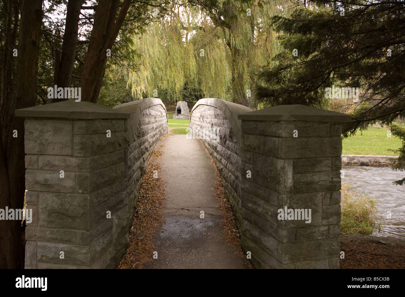 A narrow stone bridge stretches over a creek Stock Photo - Alamy