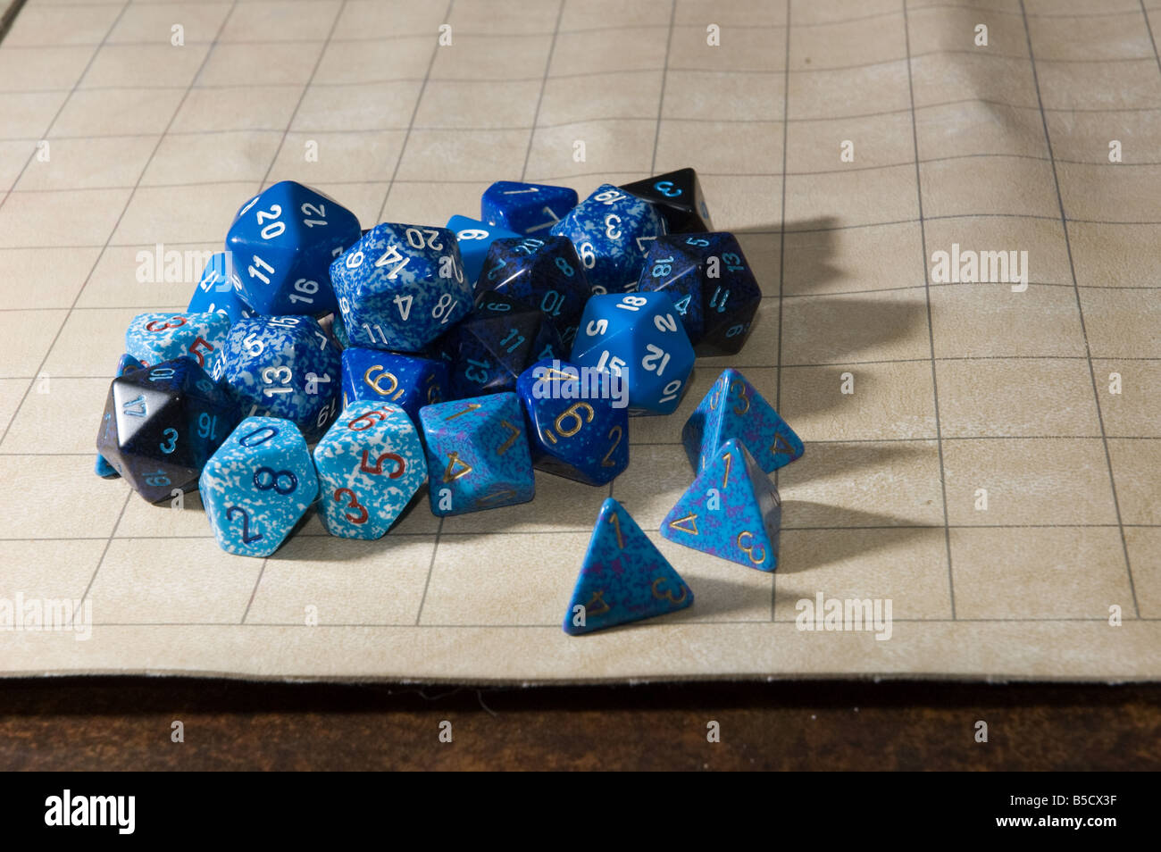A pile of polyhedron dice laying on a grid mat, used for role playing ...