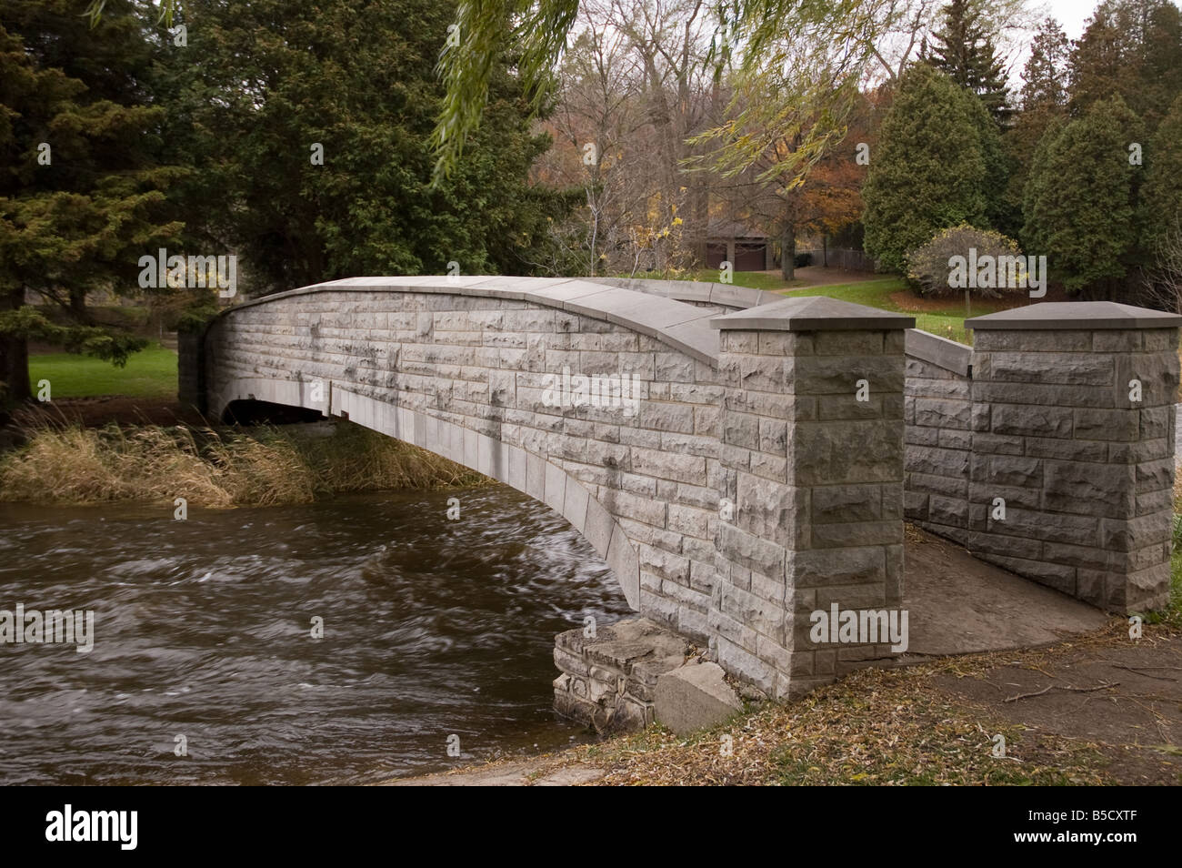 A narrow stone bridge stretches over a creek Stock Photo - Alamy
