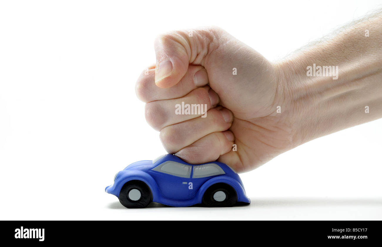 A MODEL CAR HIT AND SQUASHED BY A MANS FIST Stock Photo - Alamy