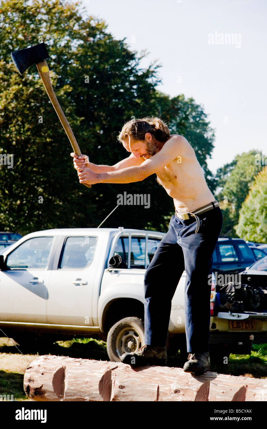 Caucasian man cutting wood Stock Photo - Alamy