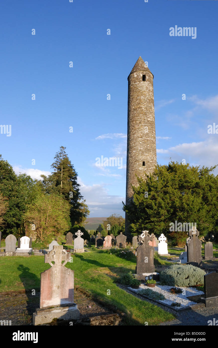 Graveyard in Glendalough at sunset with characteristic tower in ...