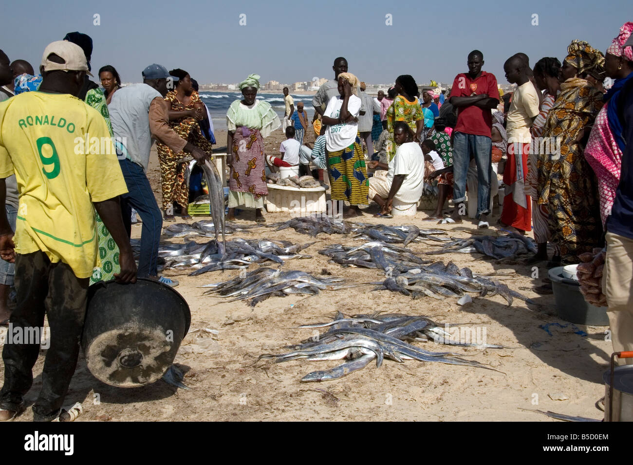 Women buying just landed fish on beach at Yoff Senegal West Africa ...