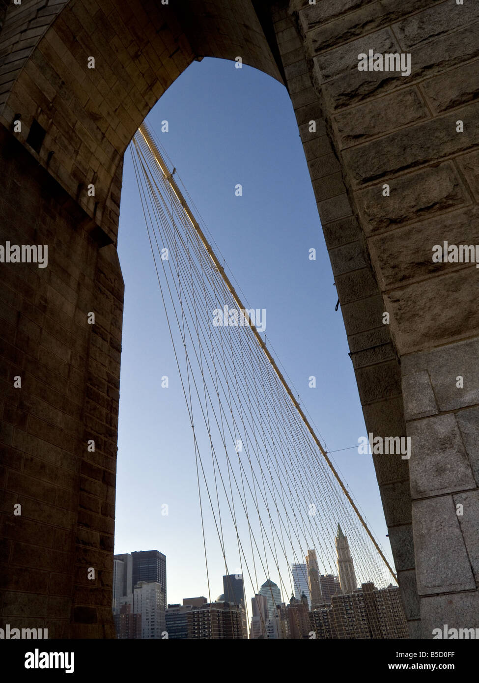Cables and towers of Brooklyn Bridge frame skyline Manhattan New York ...