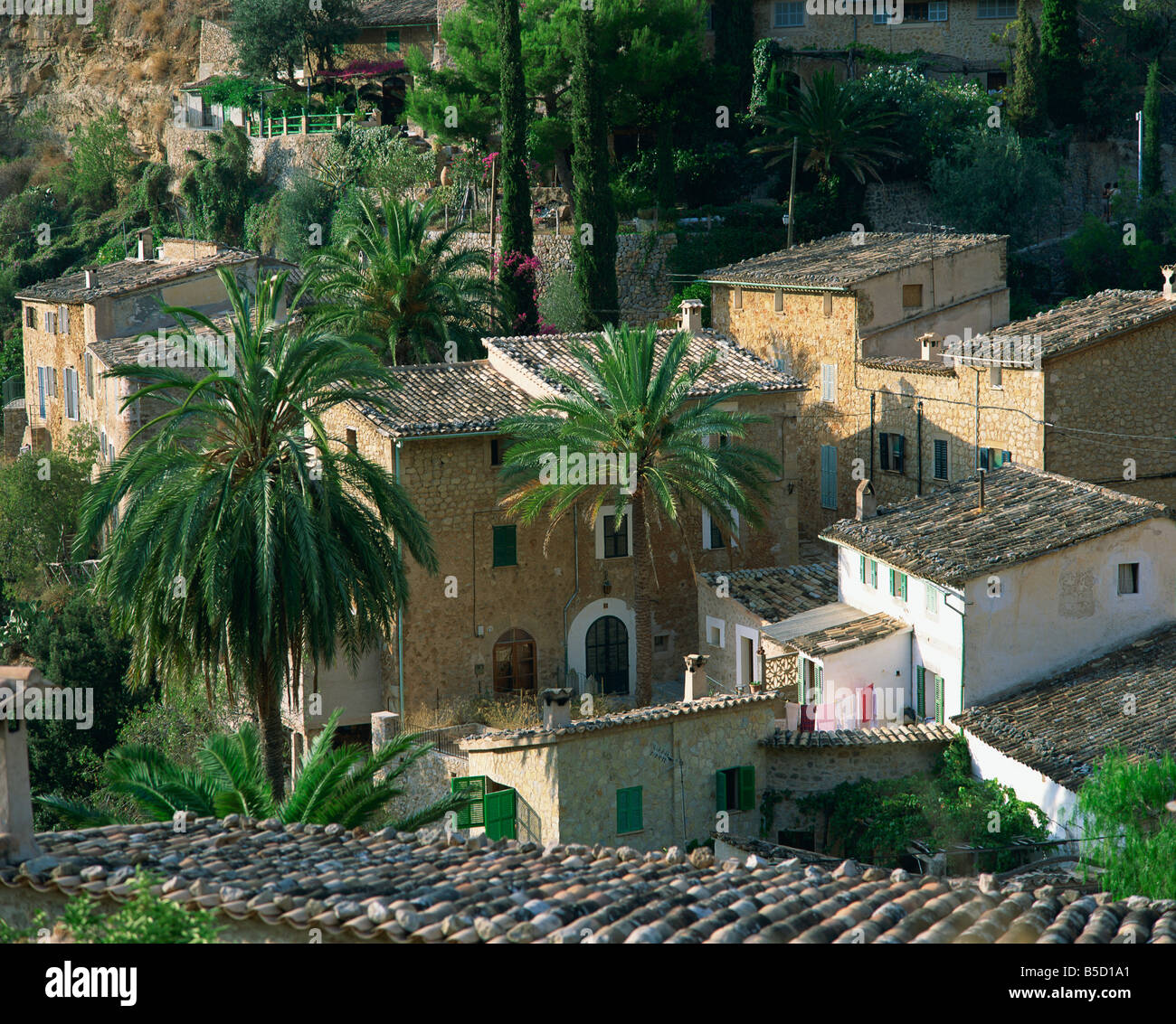 Village houses and palm trees at Deya on Majorca Balearic Islands Spain ...