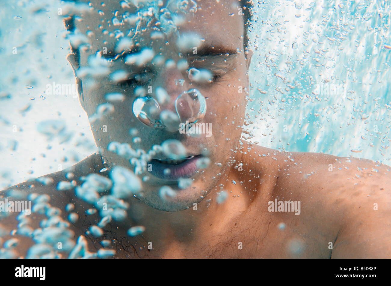 Man holding breath underwater Stock Photo - Alamy