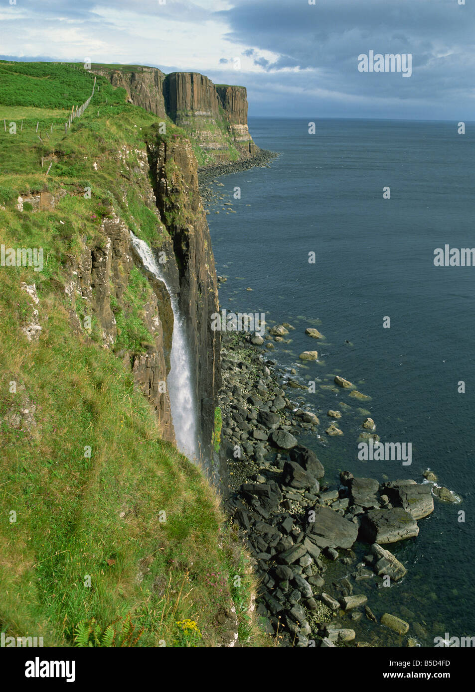 Waterfall over cliff into the sea The Kilt Rock Isle of Skye Scotland ...