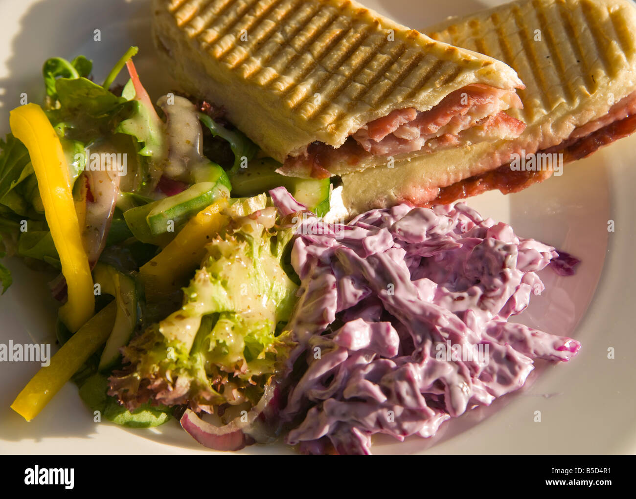 Bacon and brie panini with side salad Stock Photo - Alamy