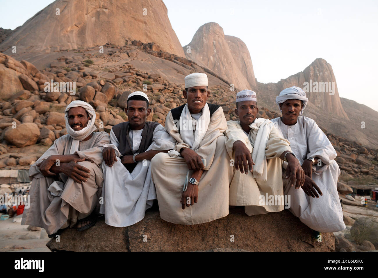 Muslim men relax in shadow of the Taka Mountain in the town of Kassala ...