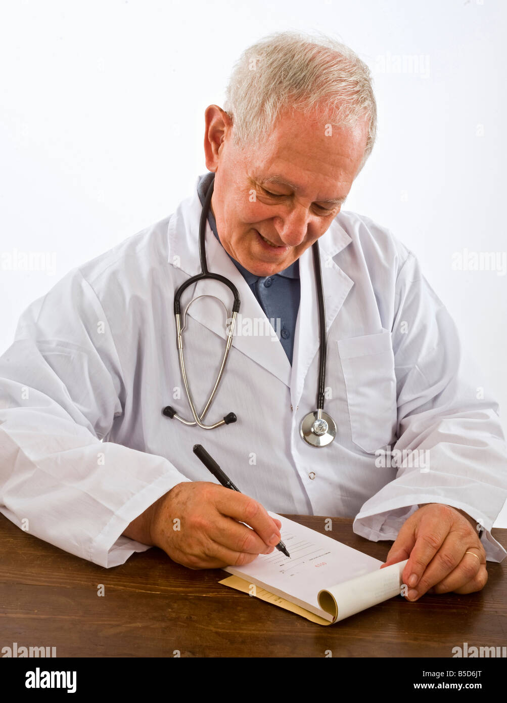 senior doctor writing a prescription Stock Photo - Alamy