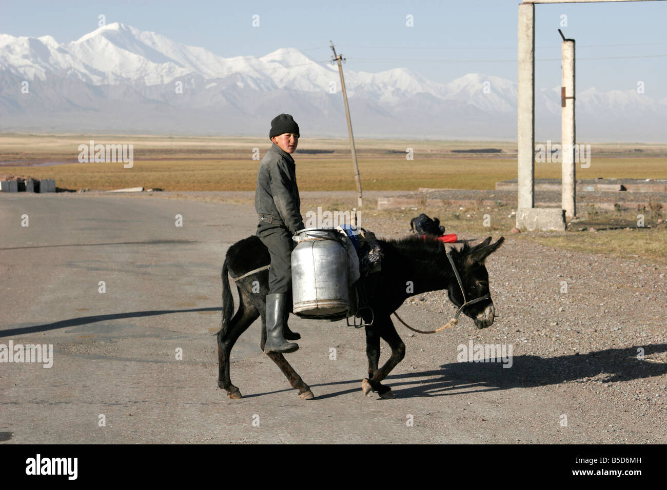 Kirghiz boy riding donkey near Sary Tash, Kyrgyzstan, Central Asia ...