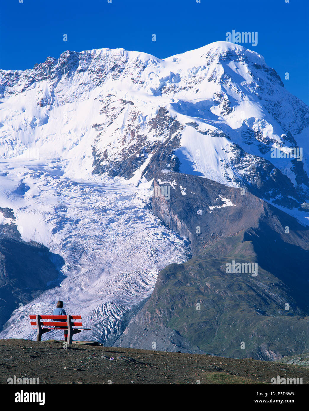 Hiker on bench, The Breithorn and Breithorn Glacier, Rotenboden ...