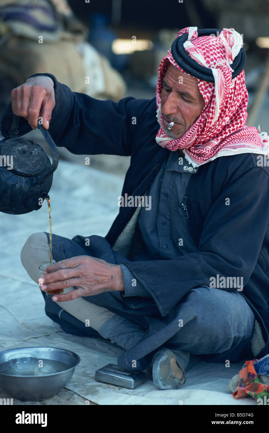 Bedouin man smoking a cigarette preparing tea Syria Middle East D C ...