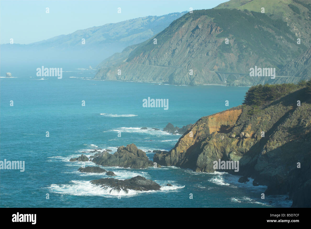 Big Sur coast along California Rt1 on a sunny day with a hint of fog in ...