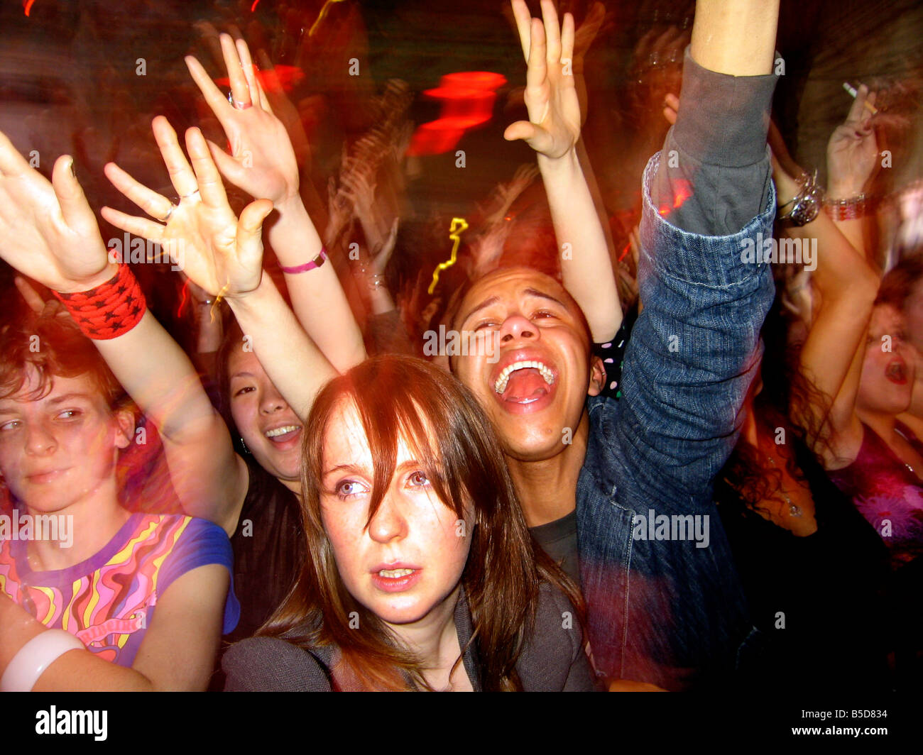 Music fans go crazy waving their hands in the air for their favourite ...