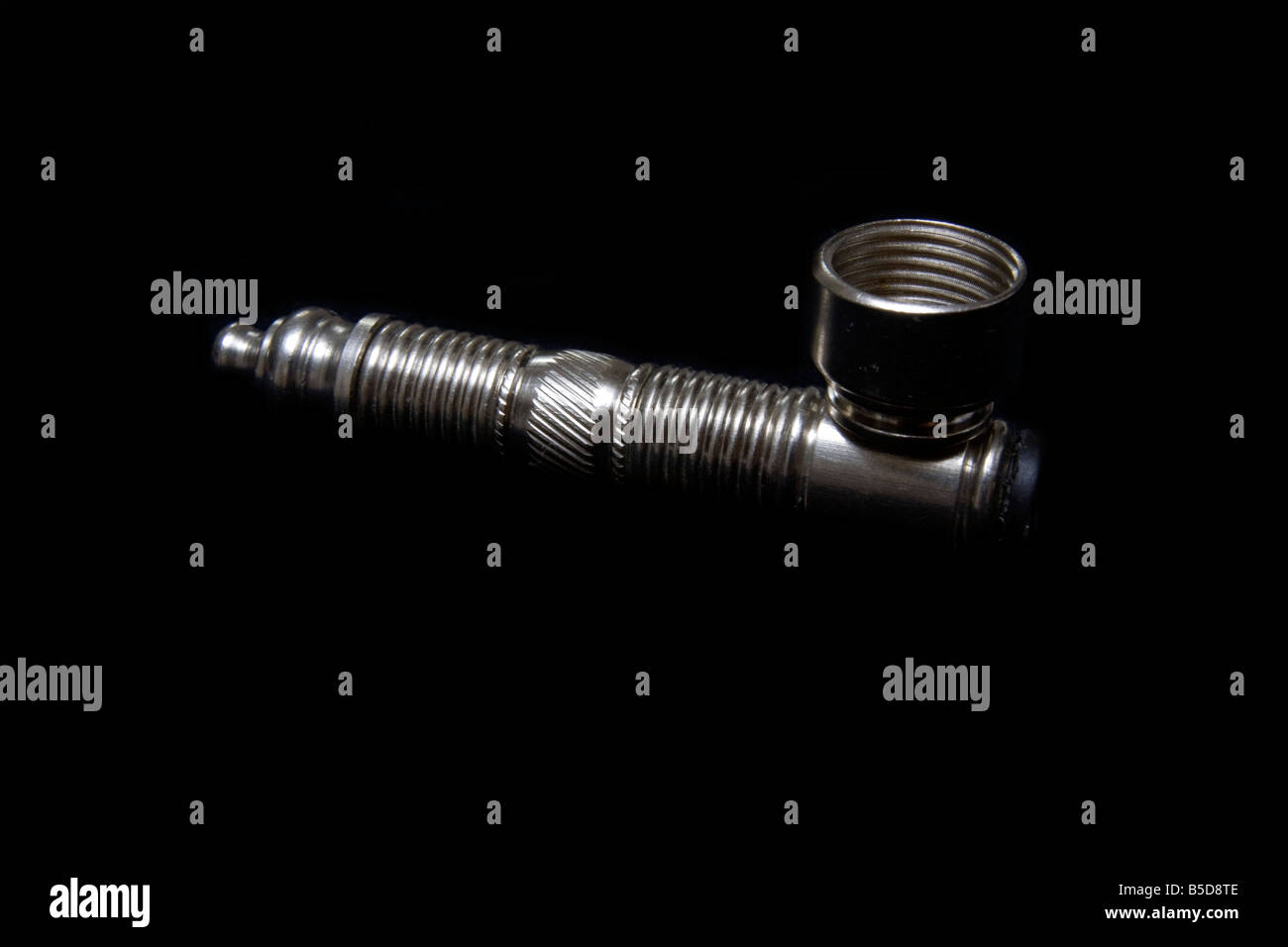 Metal crack pipe isolated on a black studio background Stock Photo - Alamy
