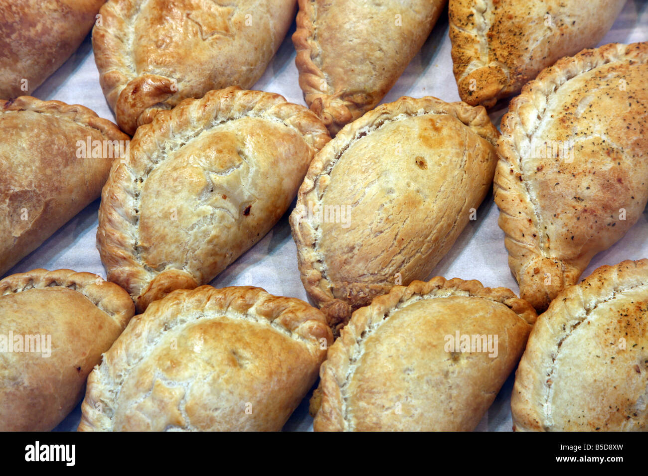 Traditional Cornish pasties on display, golden-baked pastry with ...