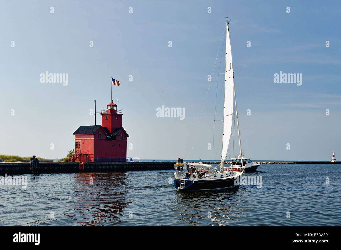Sailboat and Power Boat Cruising Past the Holland Harbor Lighthouse on ...