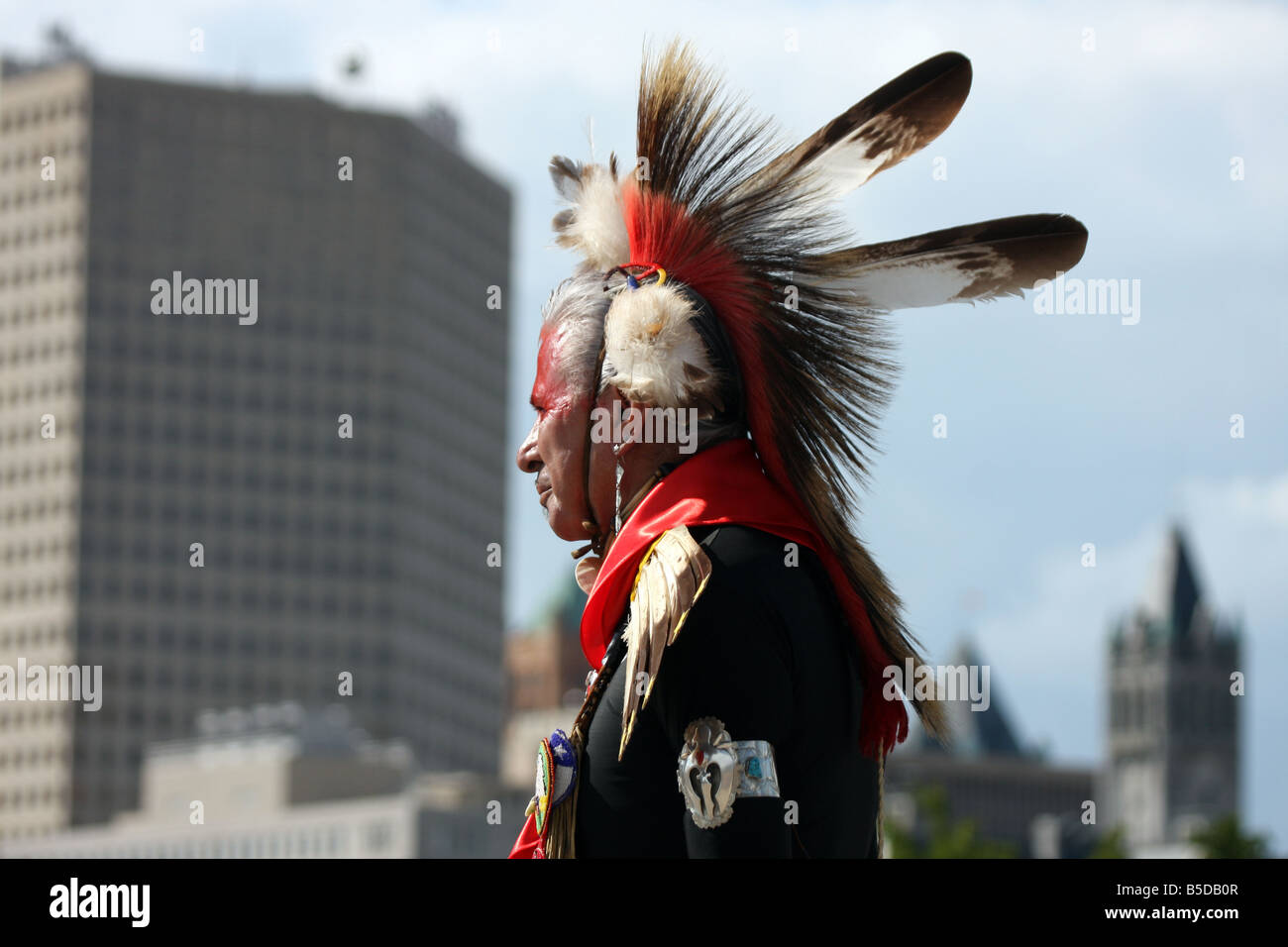 A Native American Indian man standing infront of the buildings at the ...